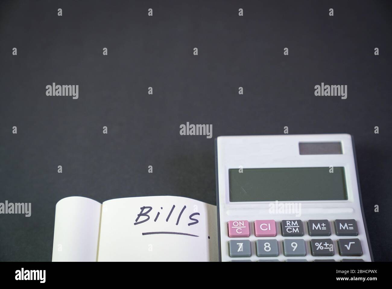Notepad with the words, Bills with calculator by the side. Black ...