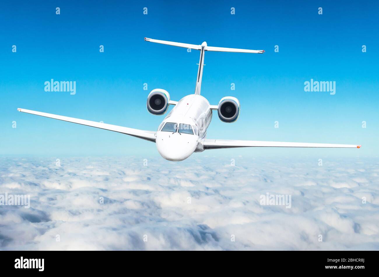 Airplane on flight level above the clouds in the blue sky Stock Photo ...