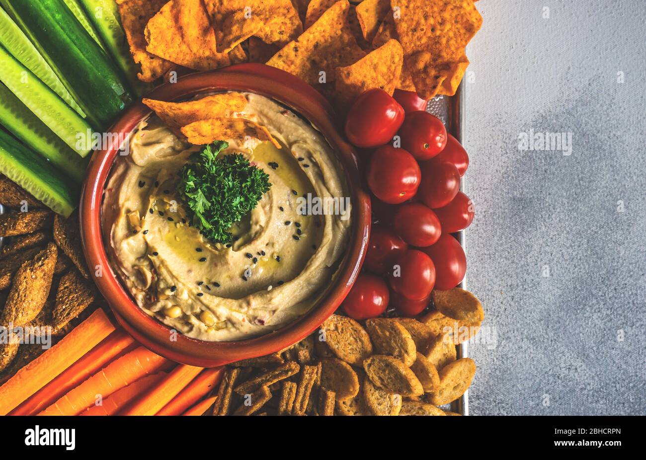 Traditional chickpeas hummus with olive oil and sesame seeds on stone ...