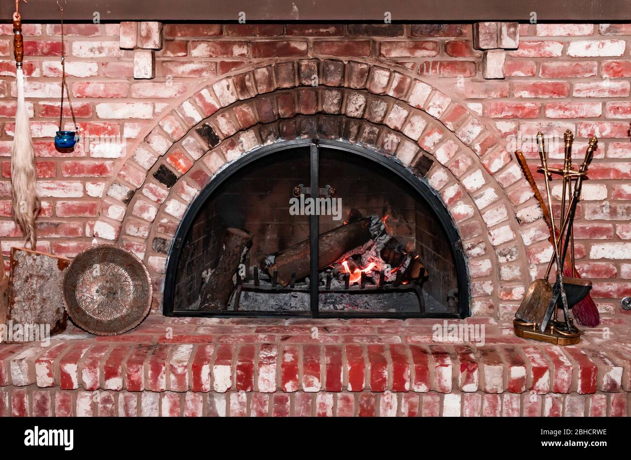 Stone bricks fireplace with glowing fire. Vintage style fireplace Stock ...
