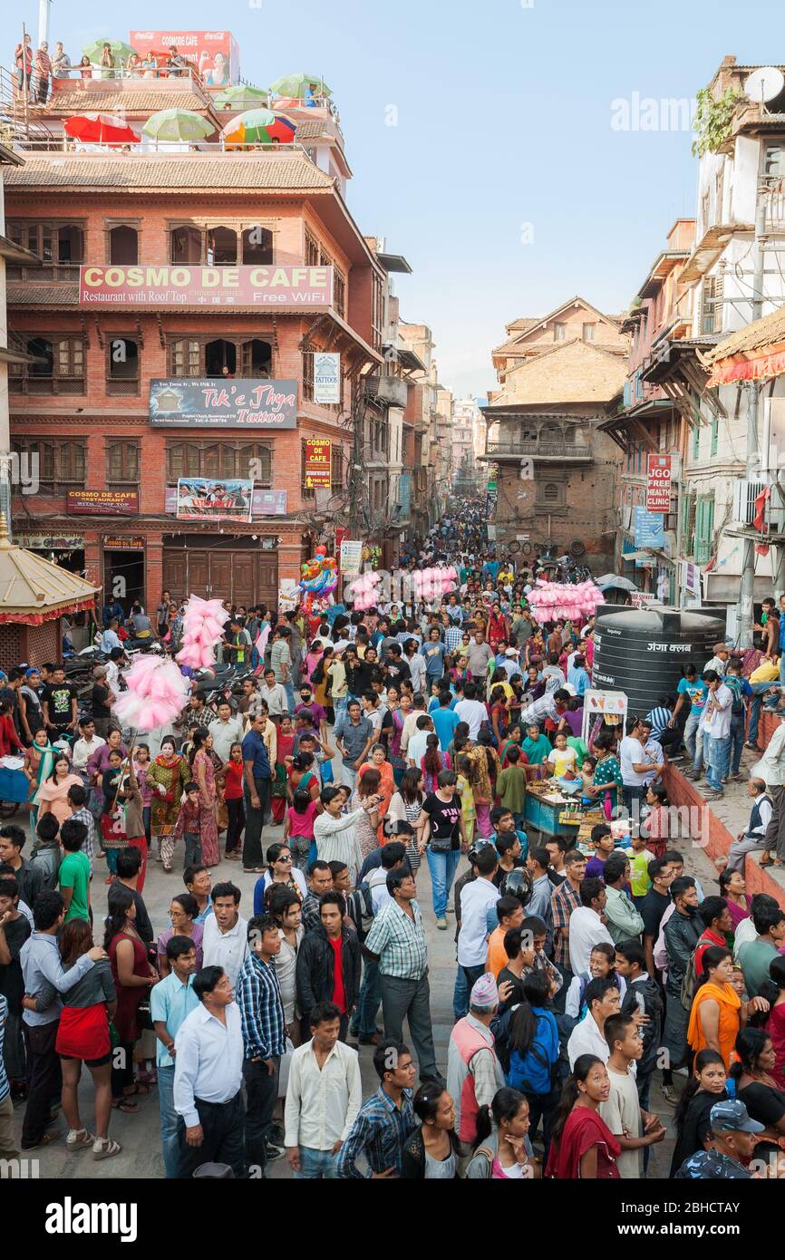 KATHMANDU, NEPAL - SEPTEMBER 29, 2012: Crowds of people walk on streets ...
