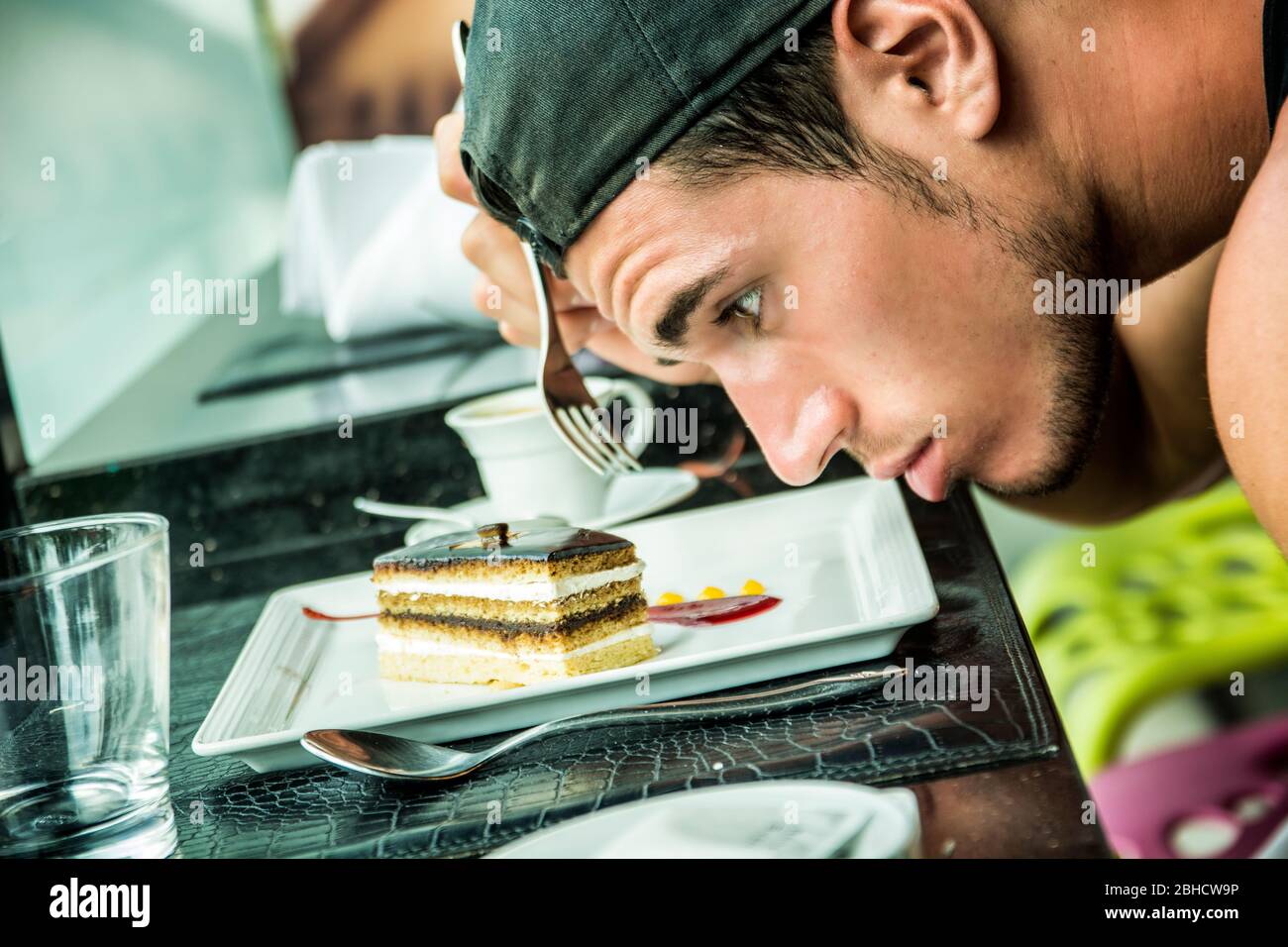 Young man eating fancy cake hi-res stock photography and images - Alamy