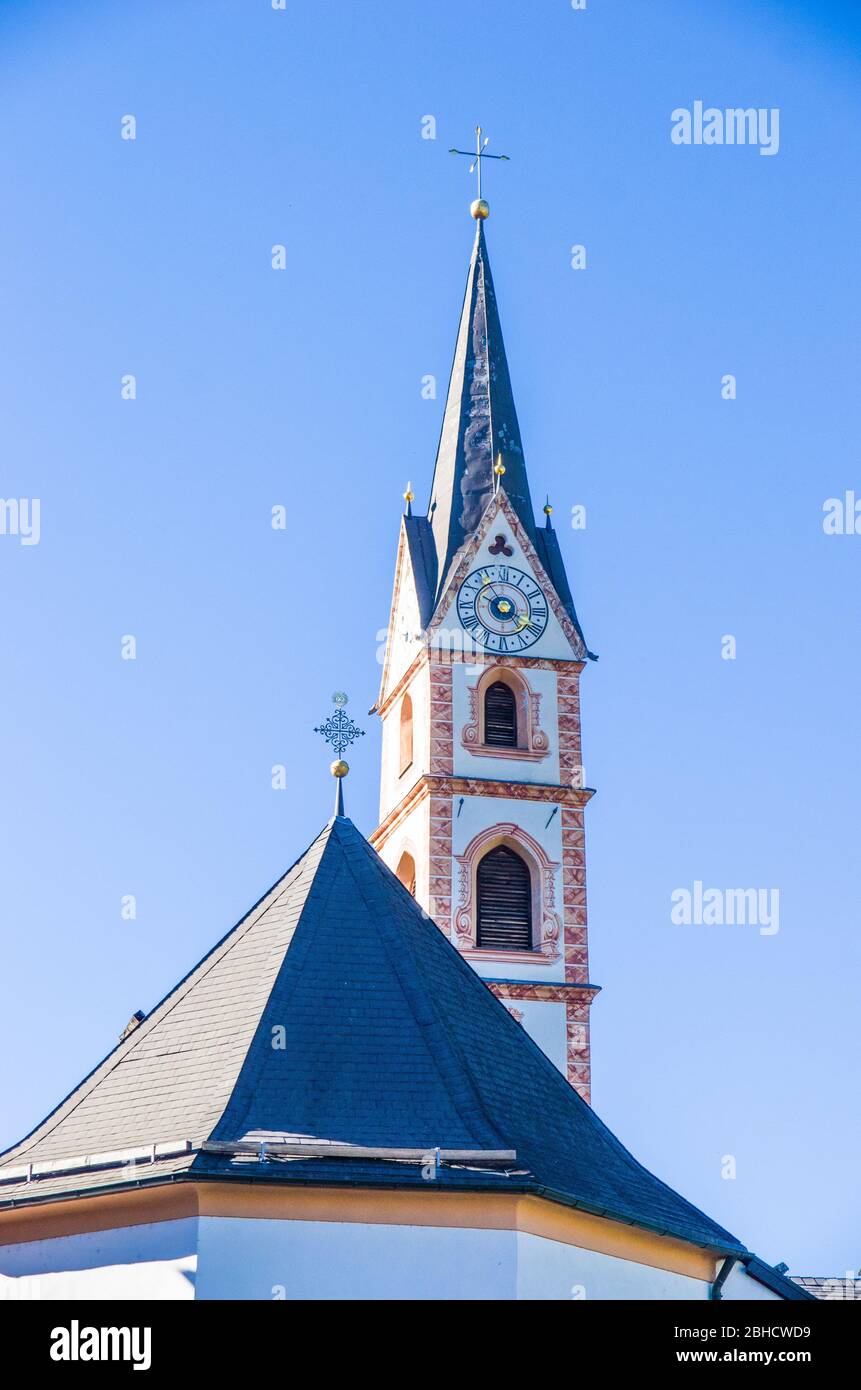 historic church with white and pink facade and red pointed bell tower ...