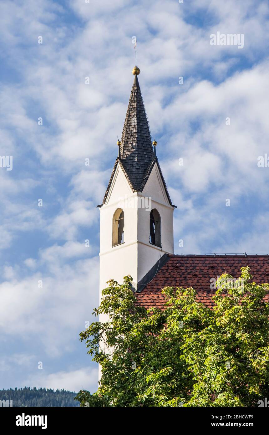 historic church with white and pink facade and red pointed bell tower ...