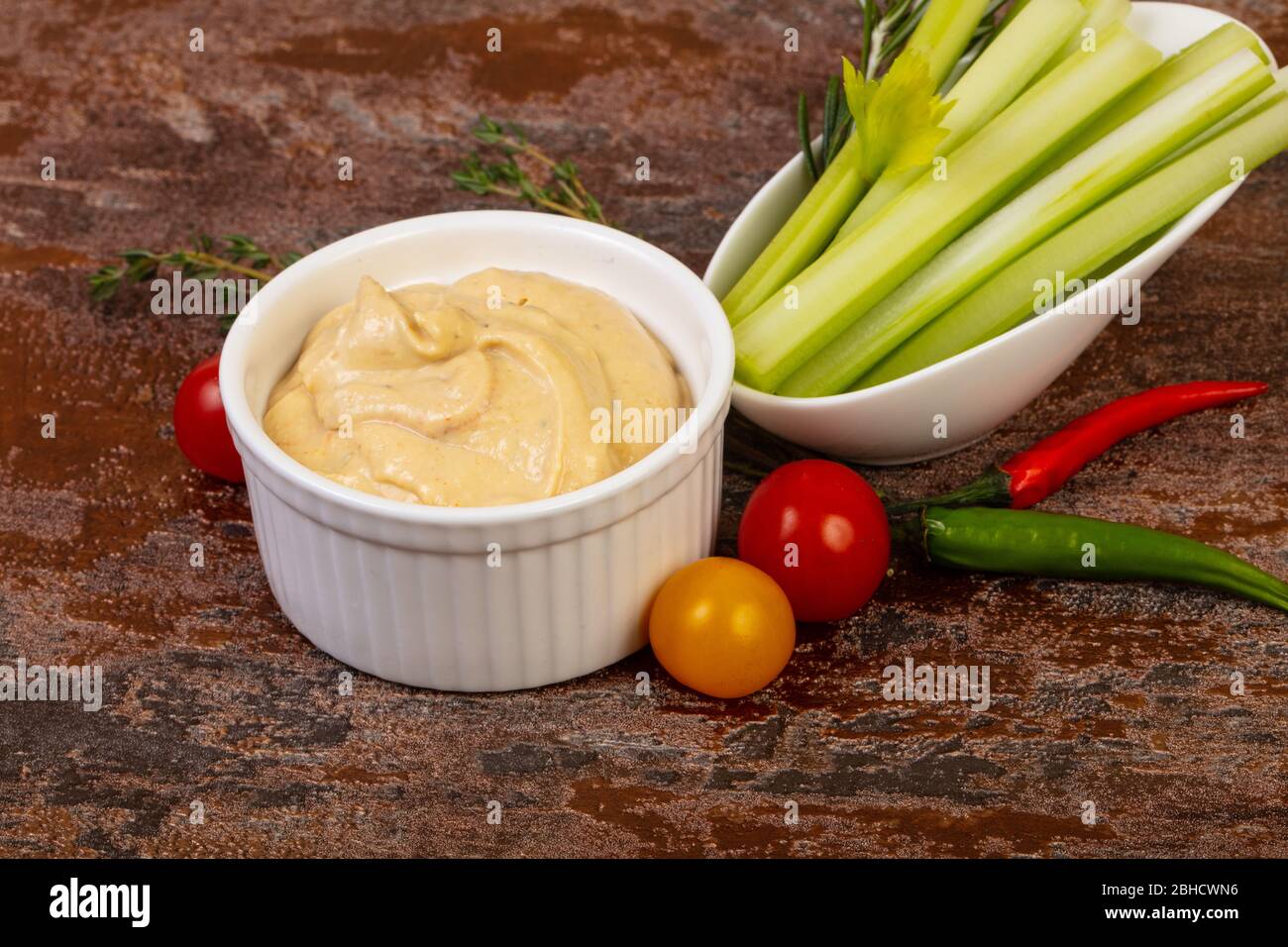 Vegan cuisine - Humus with celery sticks Stock Photo - Alamy