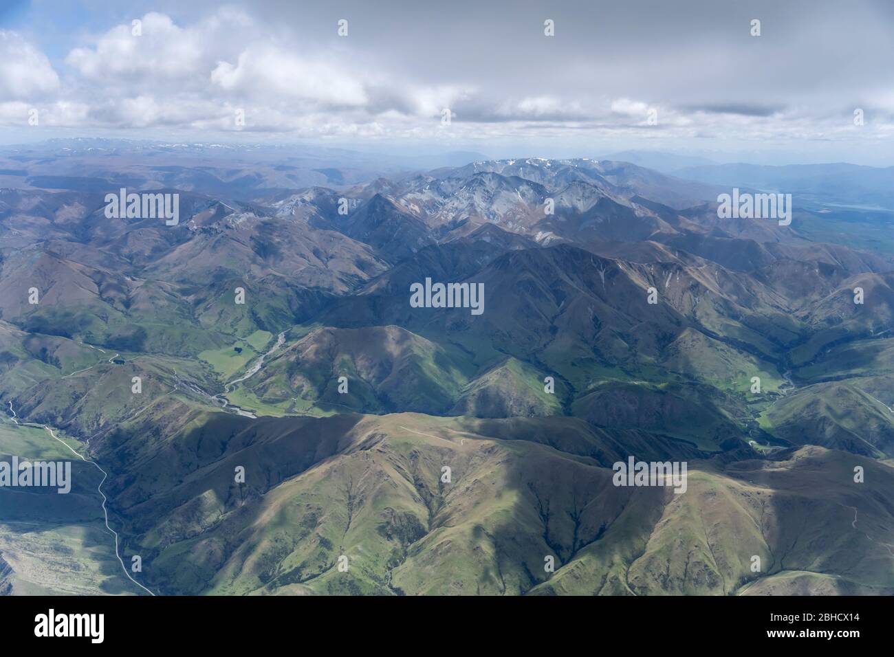 aerial, from a glider, of green Kakanui range with barren St. Mary ...