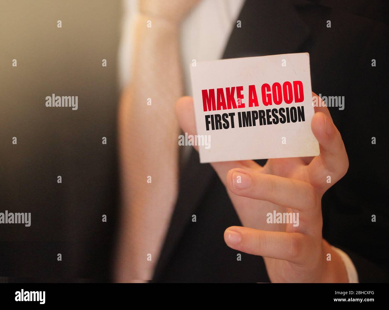 Make a good first impression on a card Businessman holding. Motivation ...