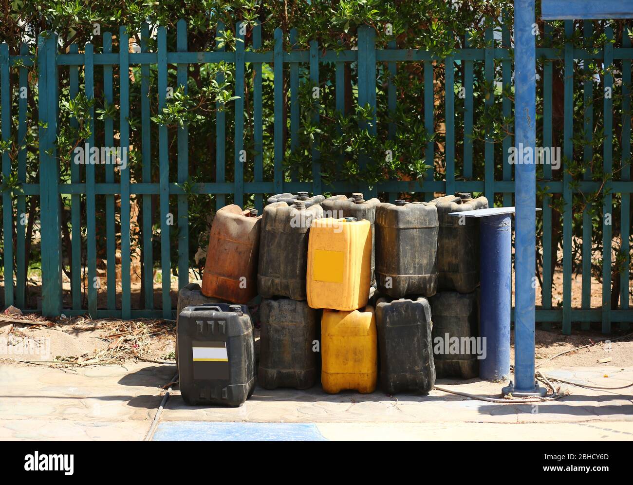 Stack of plastic canisters lying in the street Stock Photo - Alamy