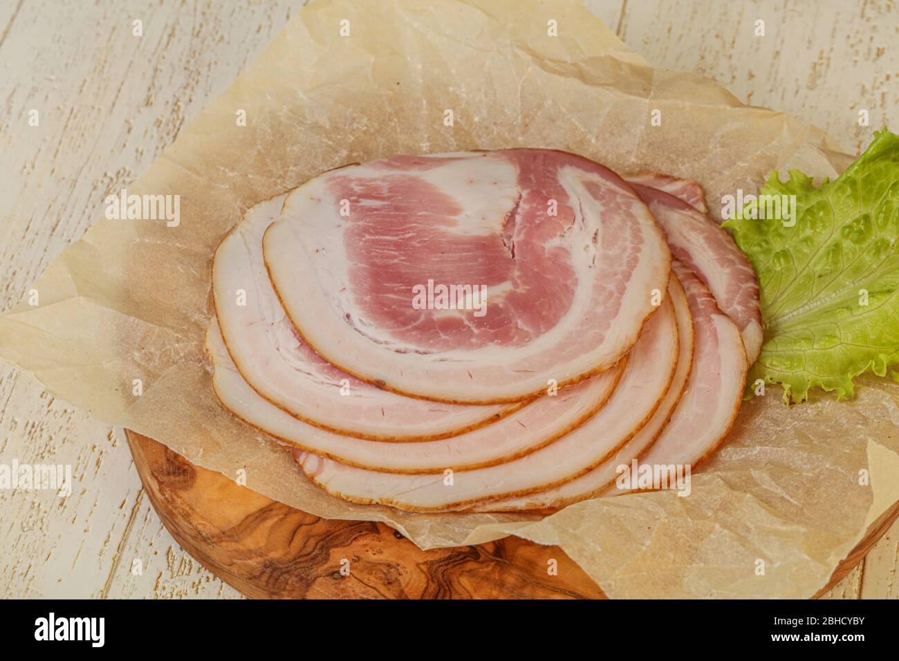 Sliced Italian Pancetta sausage over board Stock Photo - Alamy