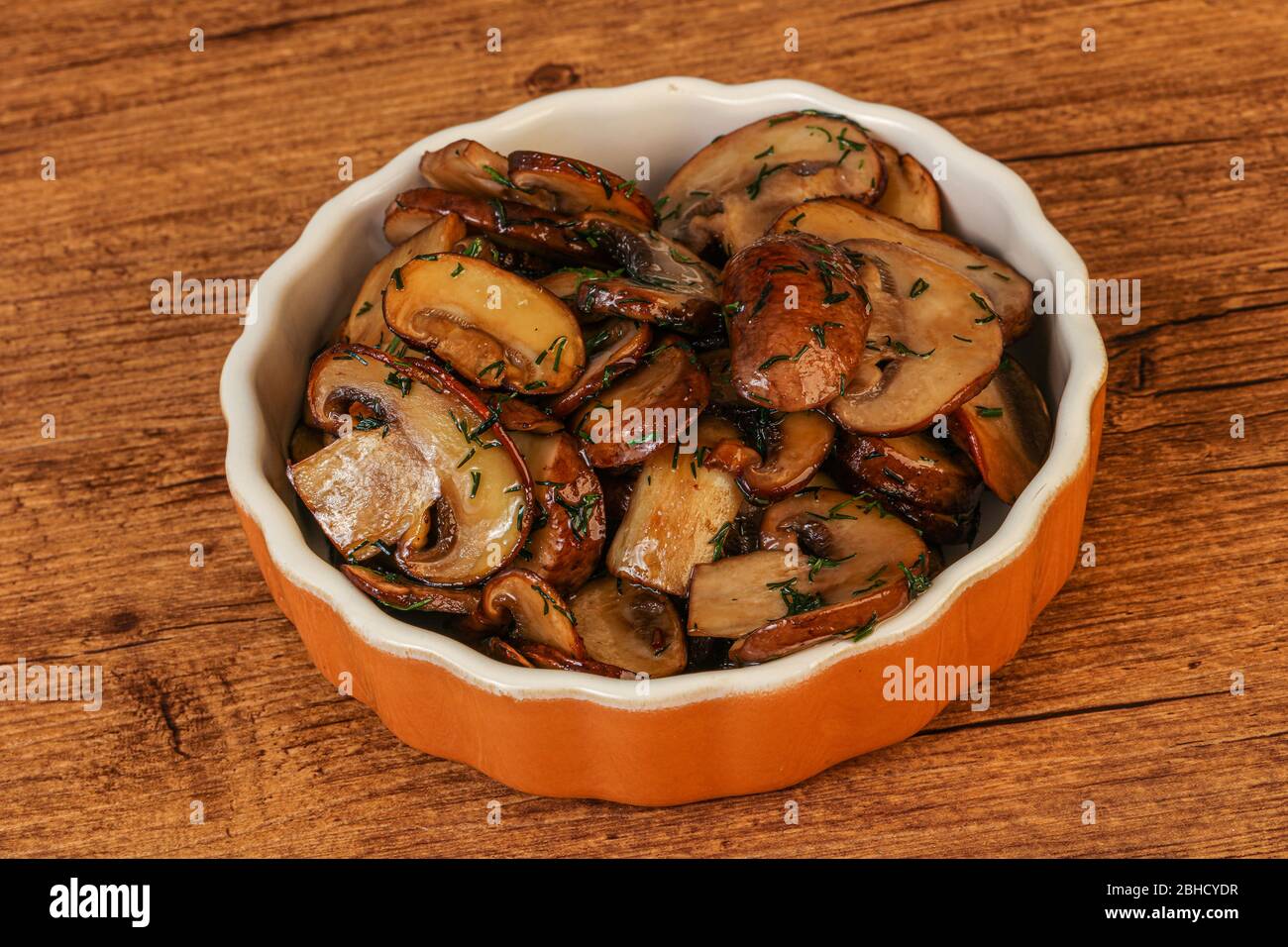 Roasted champignon with herbs and spices in the bowl Stock Photo - Alamy