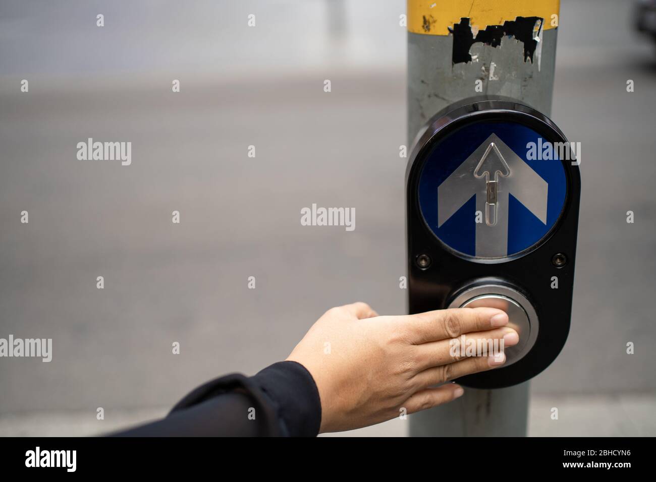 Traffic control. woman presses a finger on the button in front of a ...