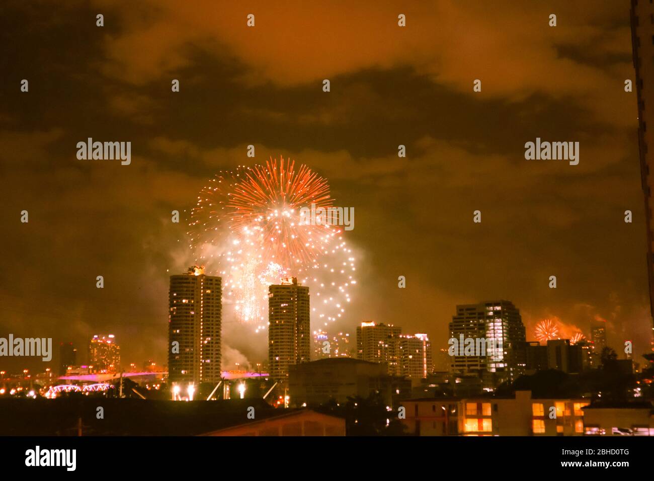 City at night in pyrotechnic explosions. fireworks on dark city sky ...