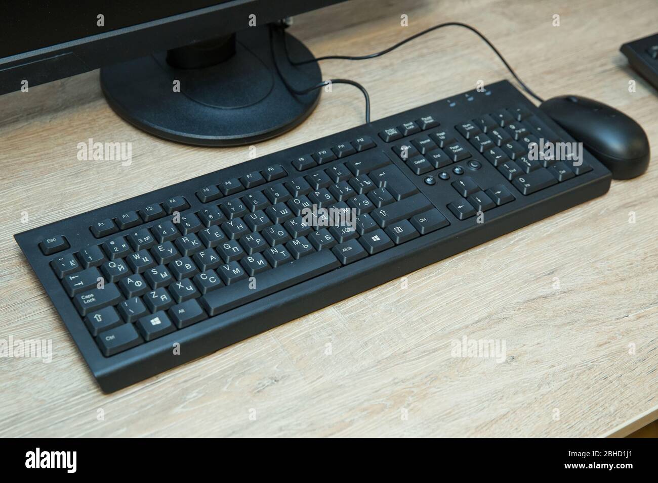 keyboard on a brown wooden table at office . Office desk table with ...