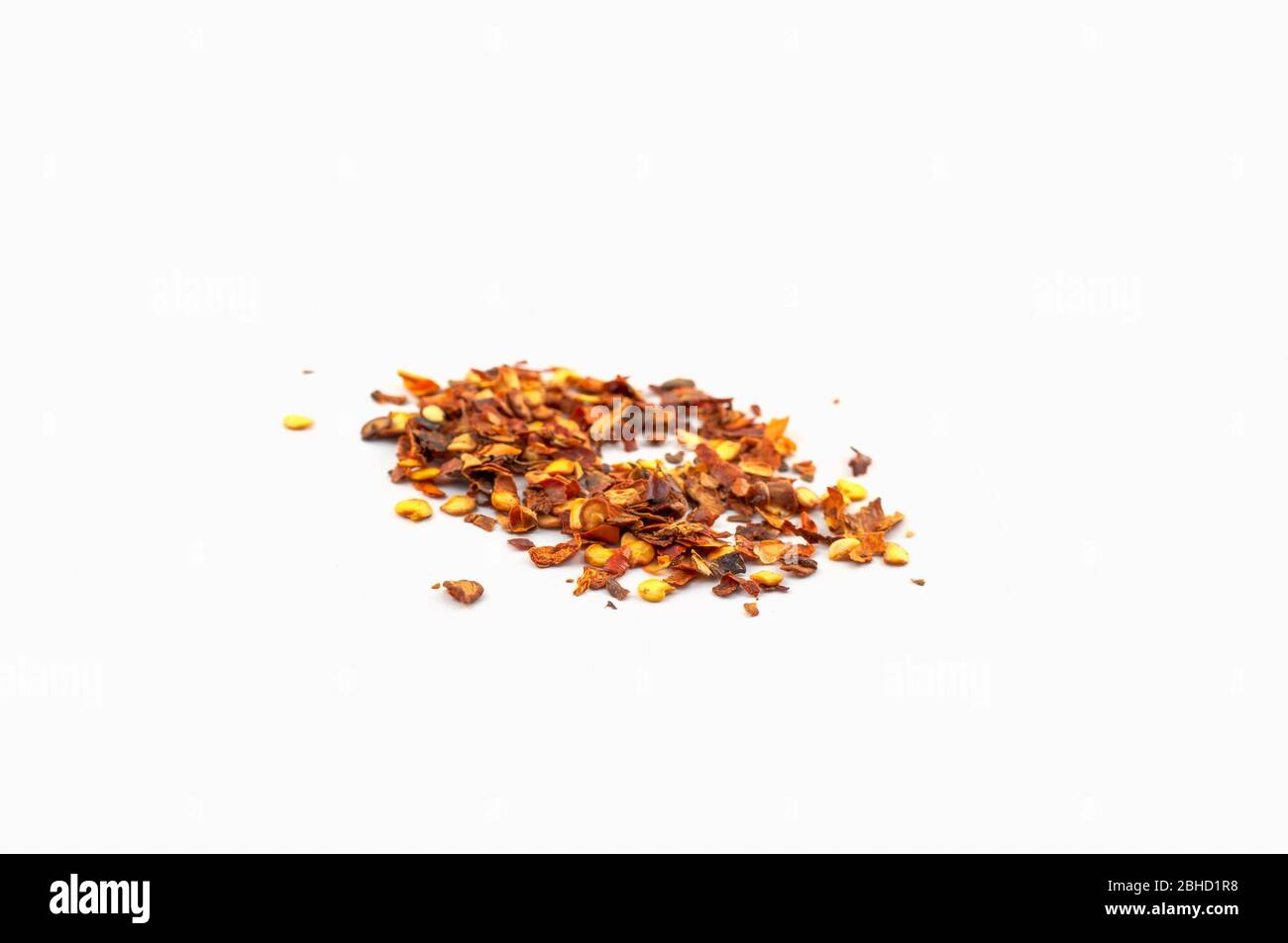 Crushed chilli flakes isolated on white background. Perfect for a spicy ...
