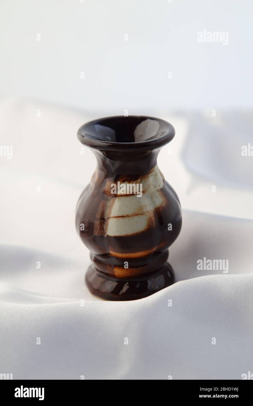 Closed up of shiny clay pot on silky background Stock Photo - Alamy