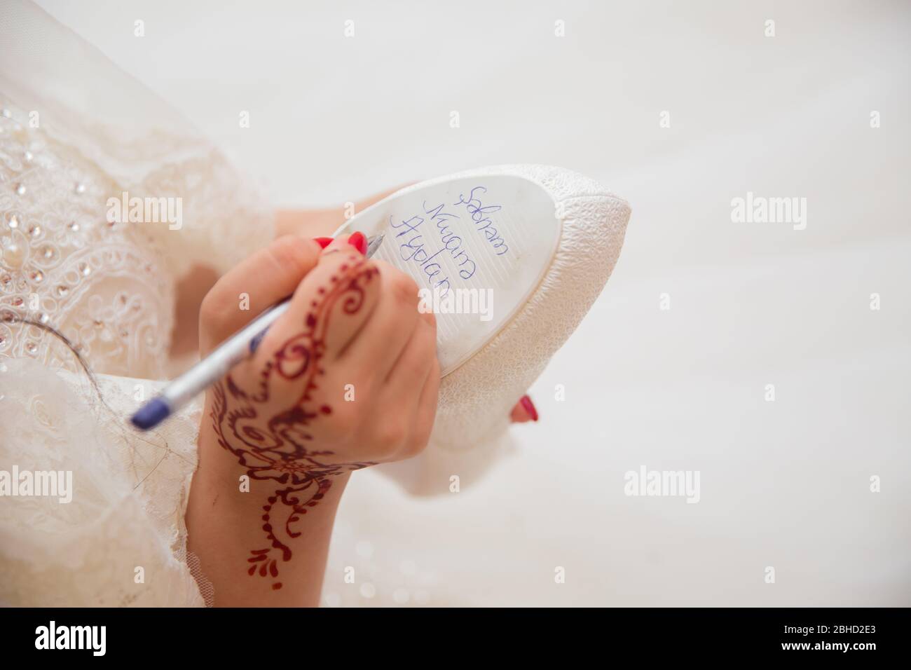 Bride writes under shoe wedding ritual superstition . hand of a bride ...