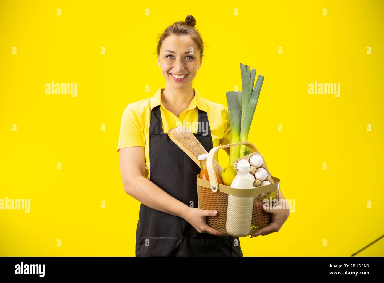 Portrait of happy farmer with basket of bio groceries and organic farm ...