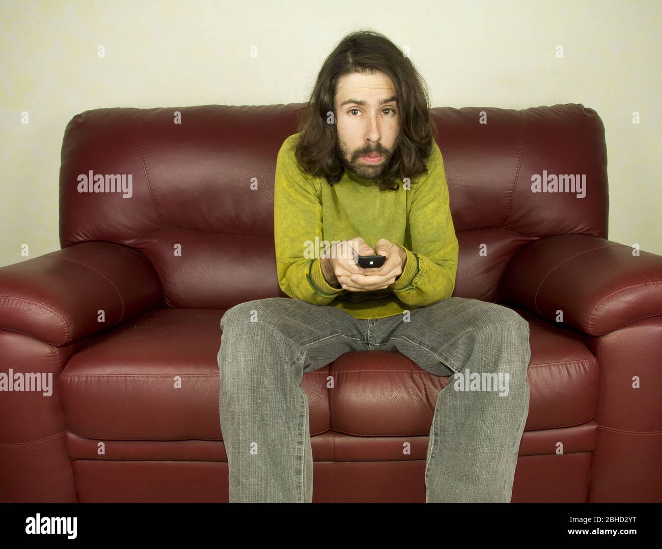 man on the couch remote control Stock Photo - Alamy