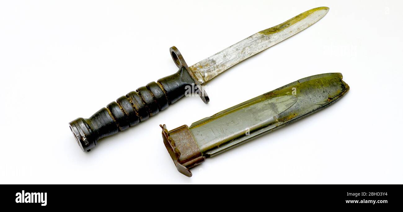old bayonet on yellow white background isolated Stock Photo - Alamy