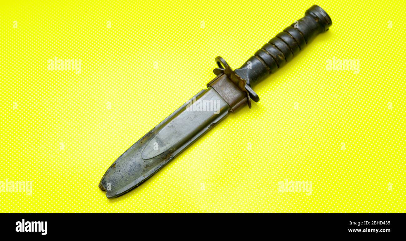 old bayonet on yellow white background isolated Stock Photo - Alamy