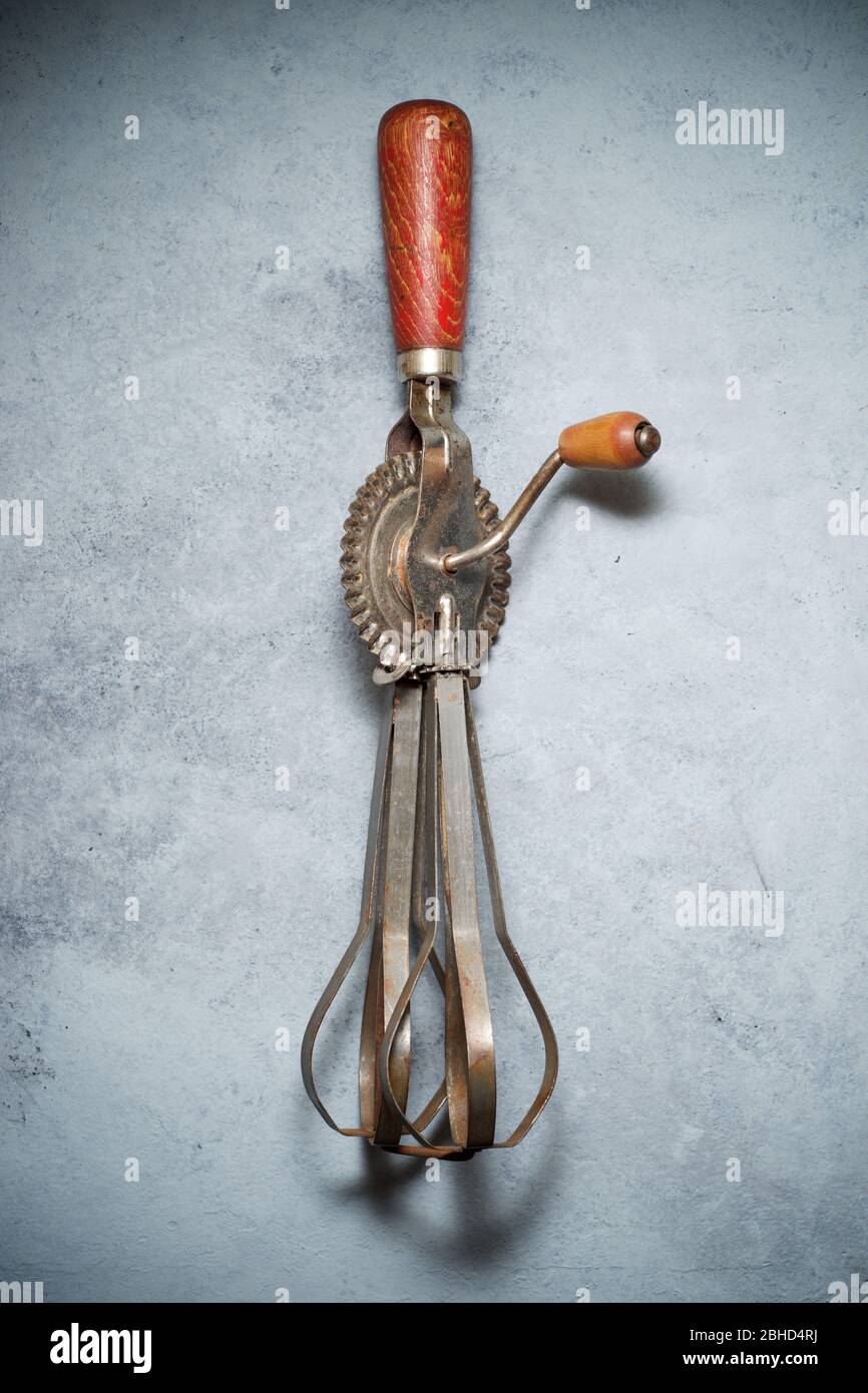 Old hand whisk on a stone table Stock Photo - Alamy