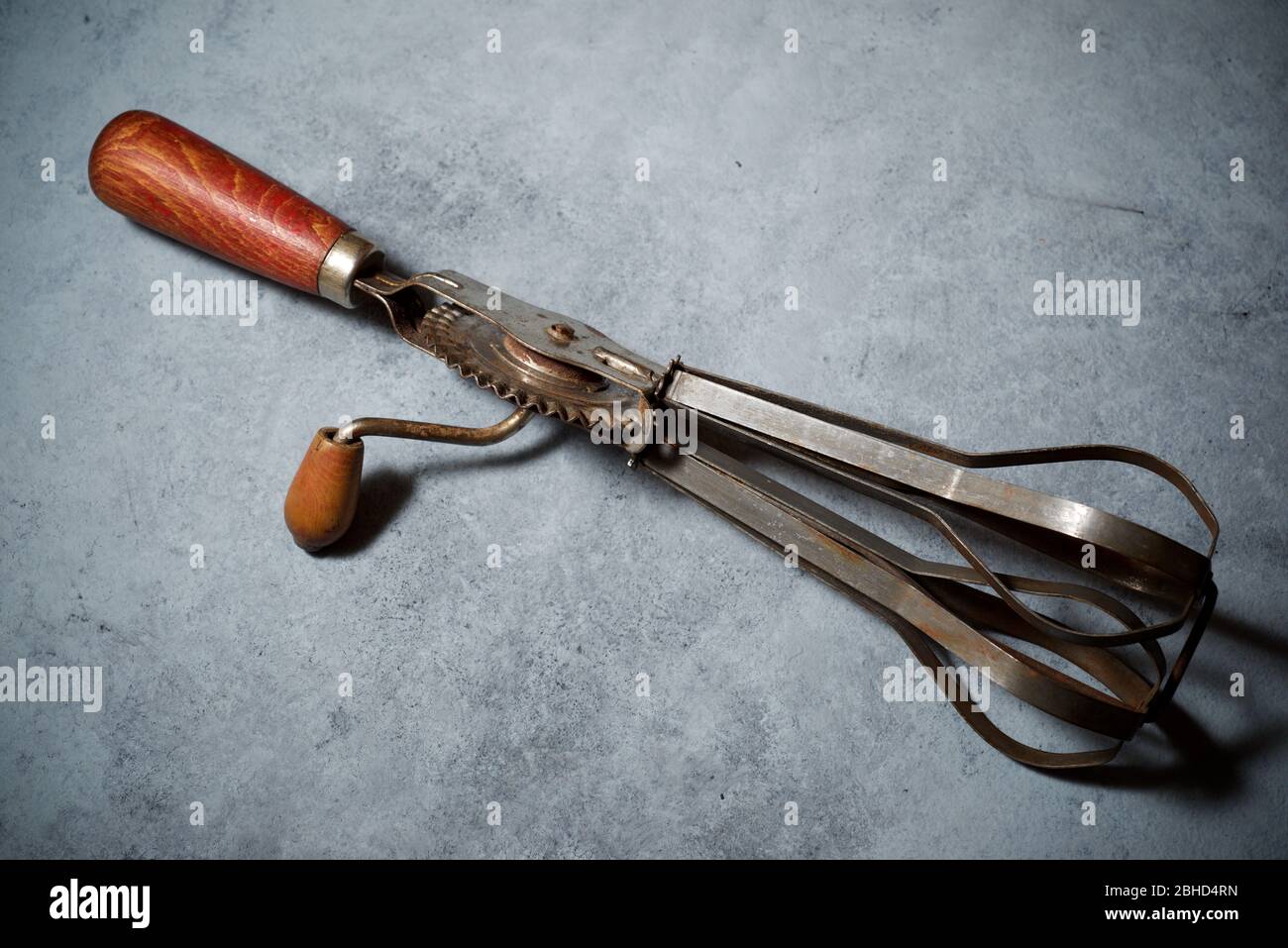 Old hand whisk on a stone table Stock Photo - Alamy