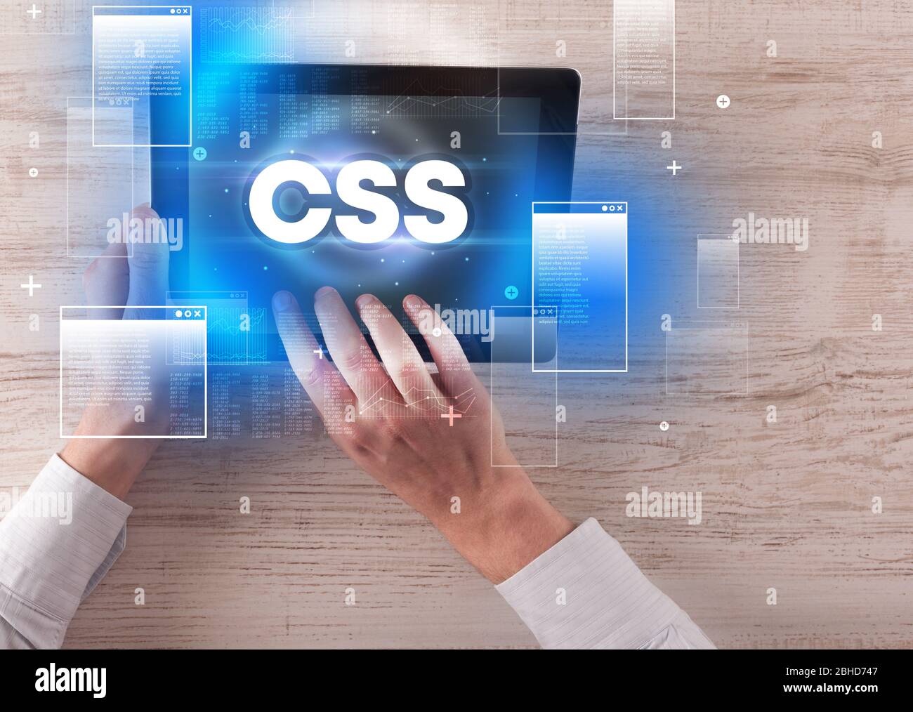 Close-up of a hand holding tablet with CSS abbreviation, modern ...