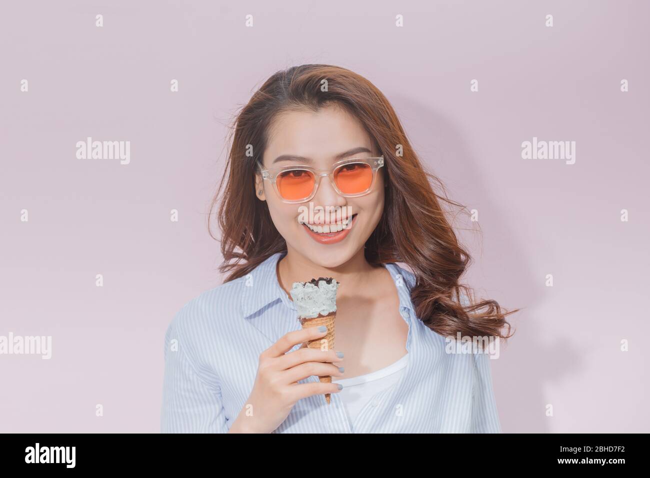 Pretty Asian girl eating junk food by not diet or loss weight concept ...