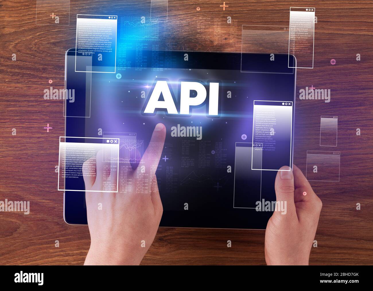 Close-up of a hand holding tablet with API abbreviation, modern ...