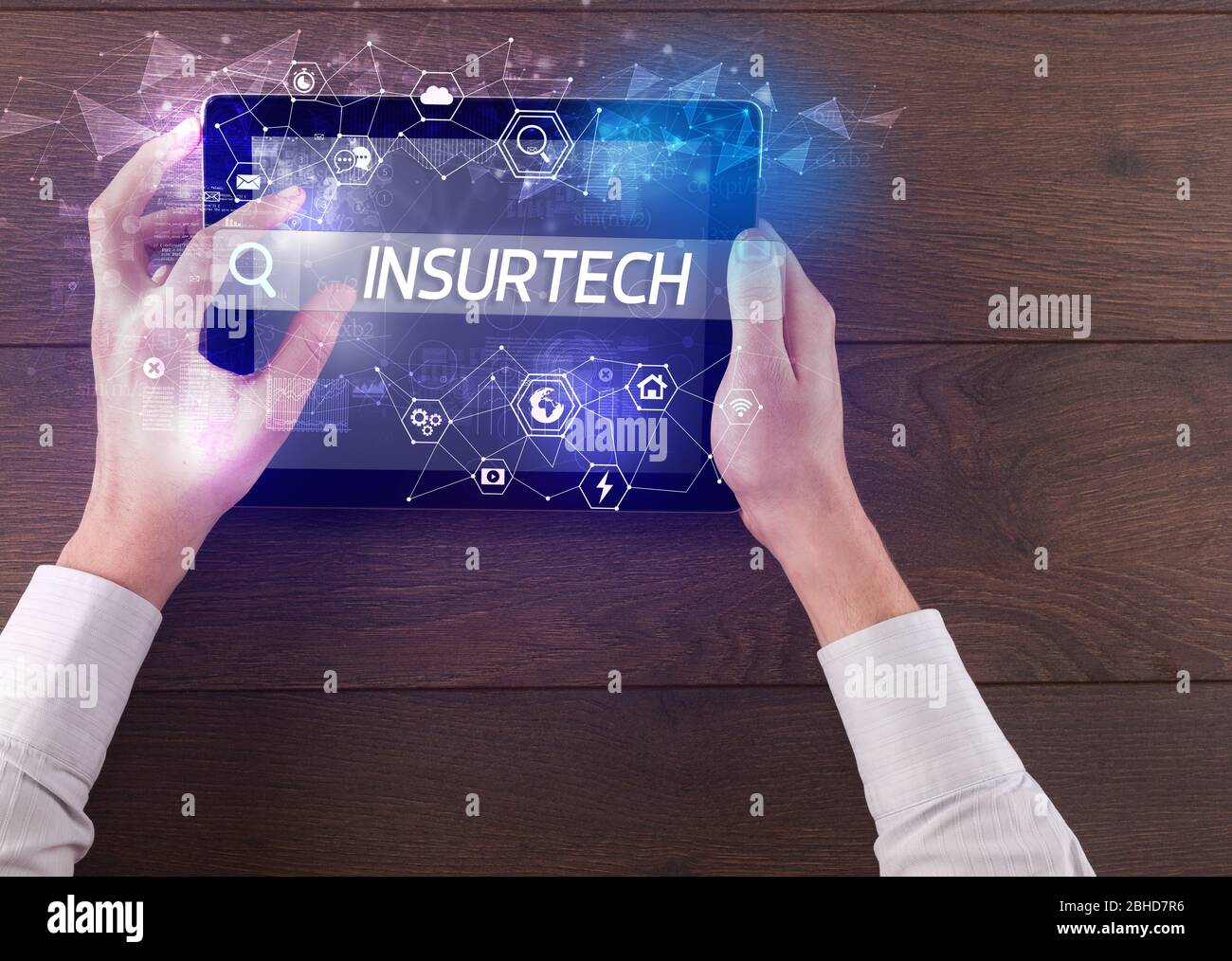 Close-up of a tablet searching INSURTECH inscription, hi-tech computing ...