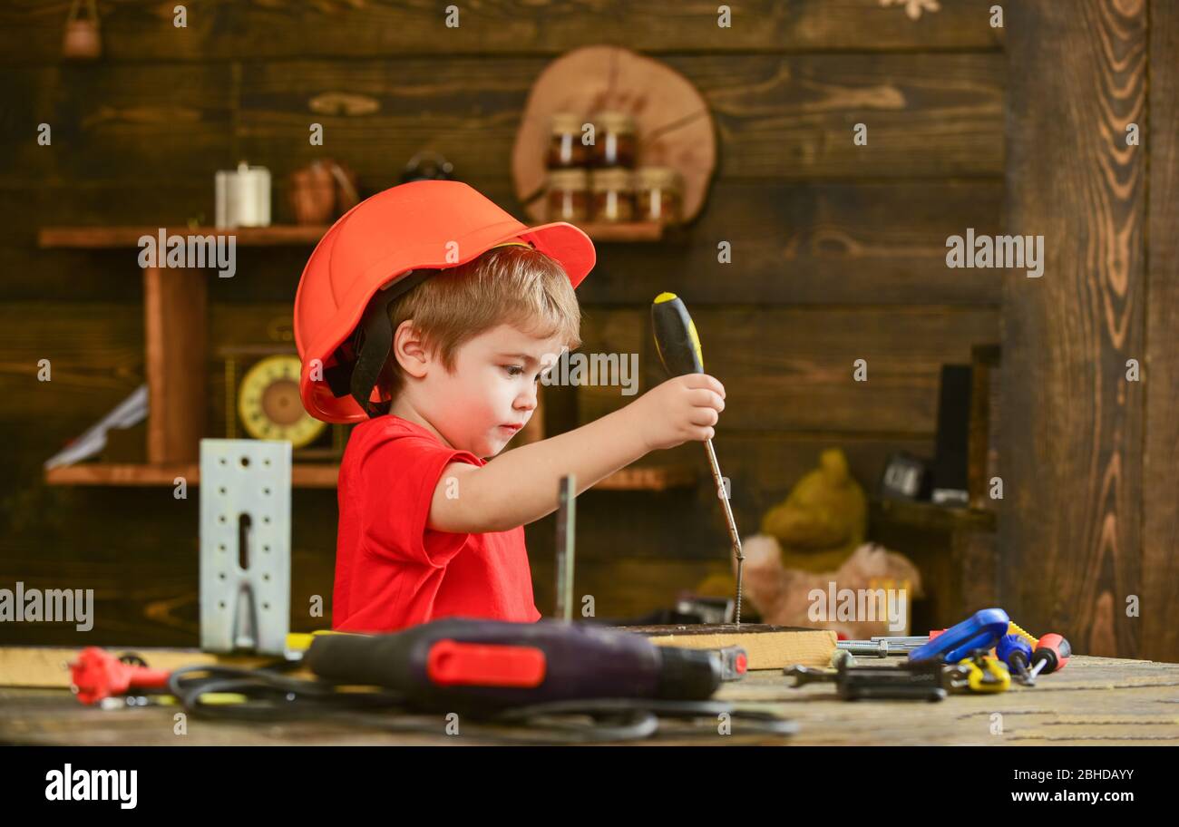 Handcrafting and workshop concept. Child in helmet cute playing as ...