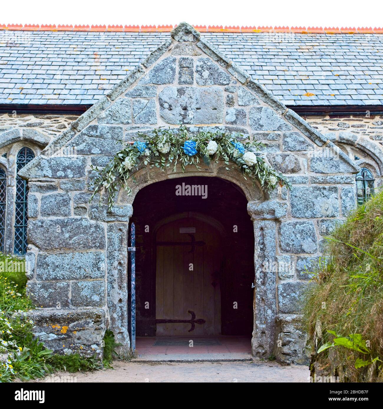 The 16th Century front porch of the Church of St Winwaloe, Gunwalloe ...