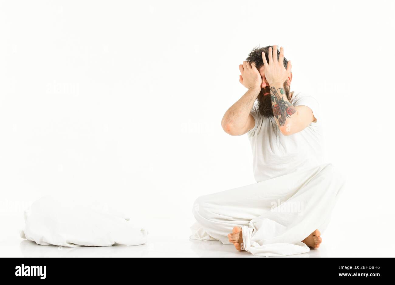 Man still drowsy in morning, white background. Hipster with beard and ...