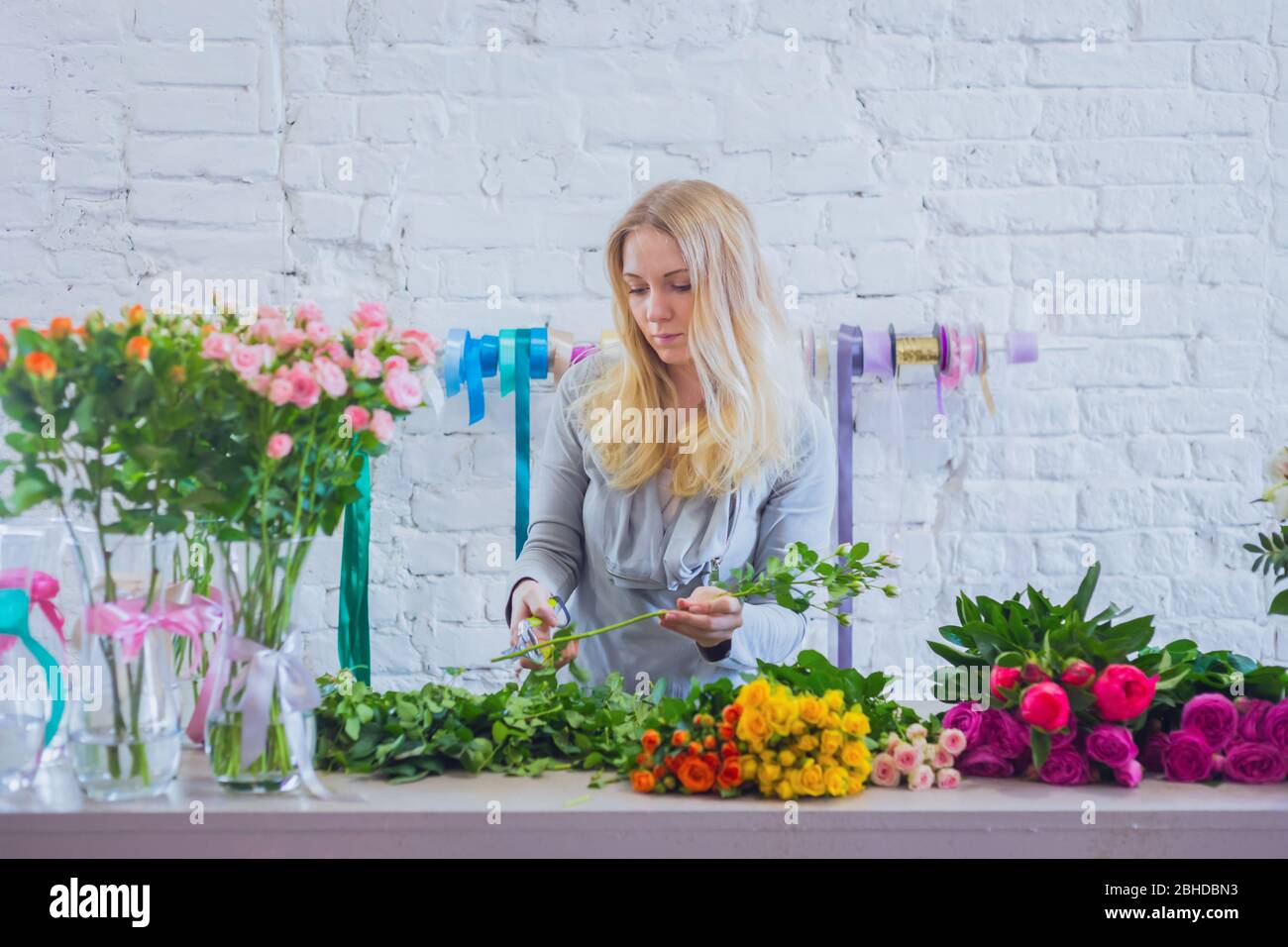 Professional floral artist florist cutting hi-res stock photography and ...