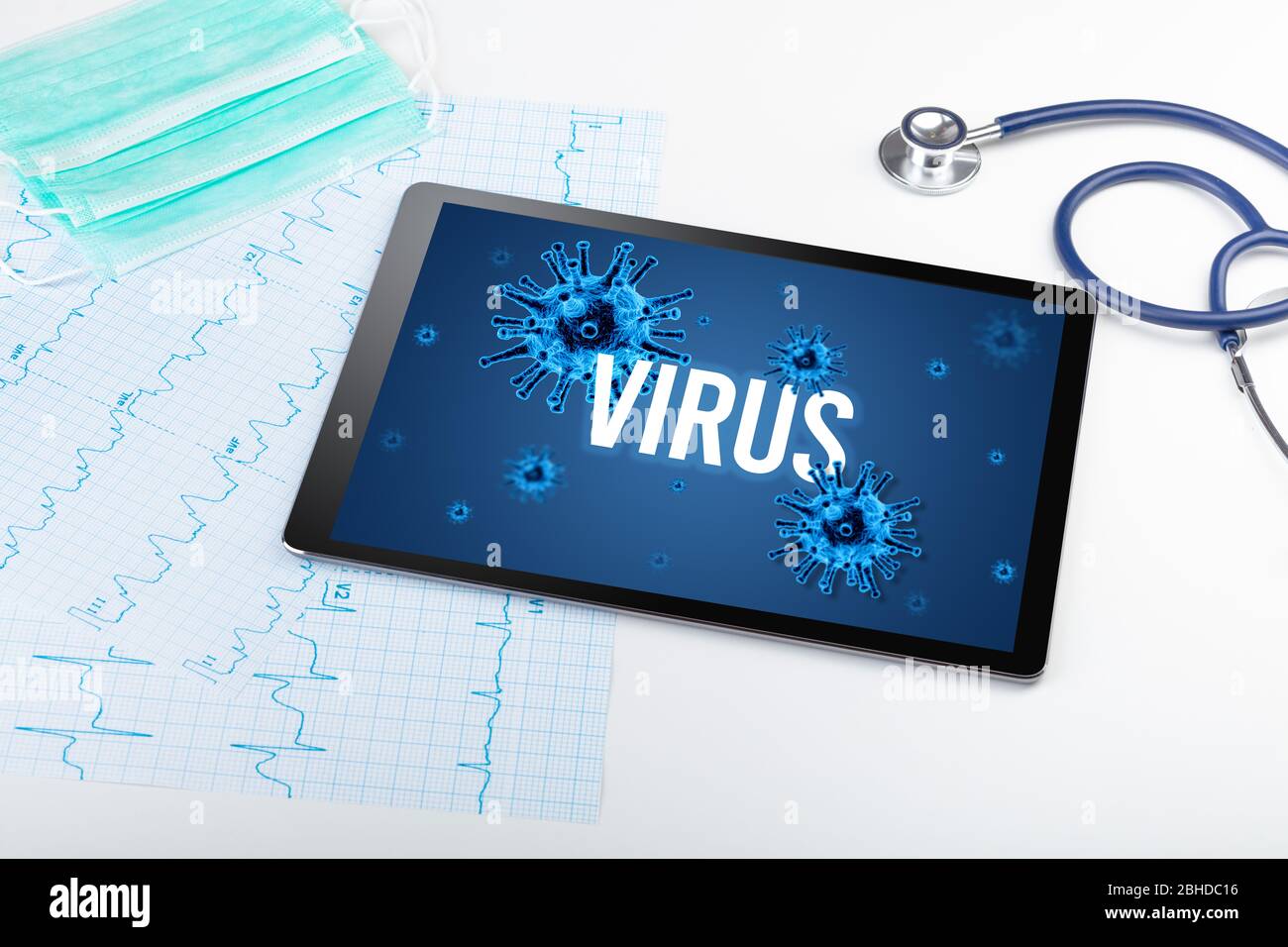 Tablet pc and doctor tools on white surface with VIRUS inscription ...