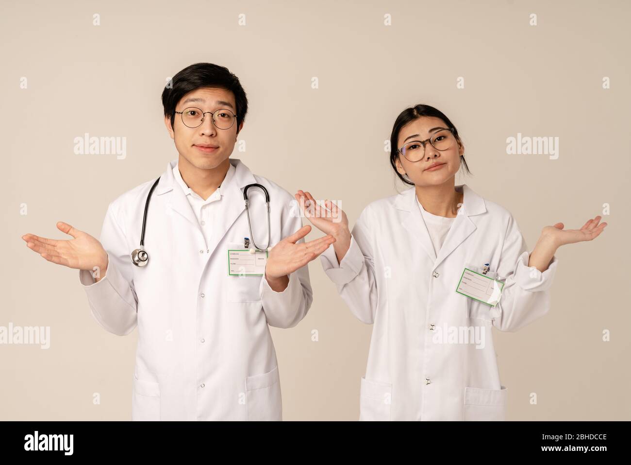 Image of asian young medical doctors in white uniform shrugging and ...