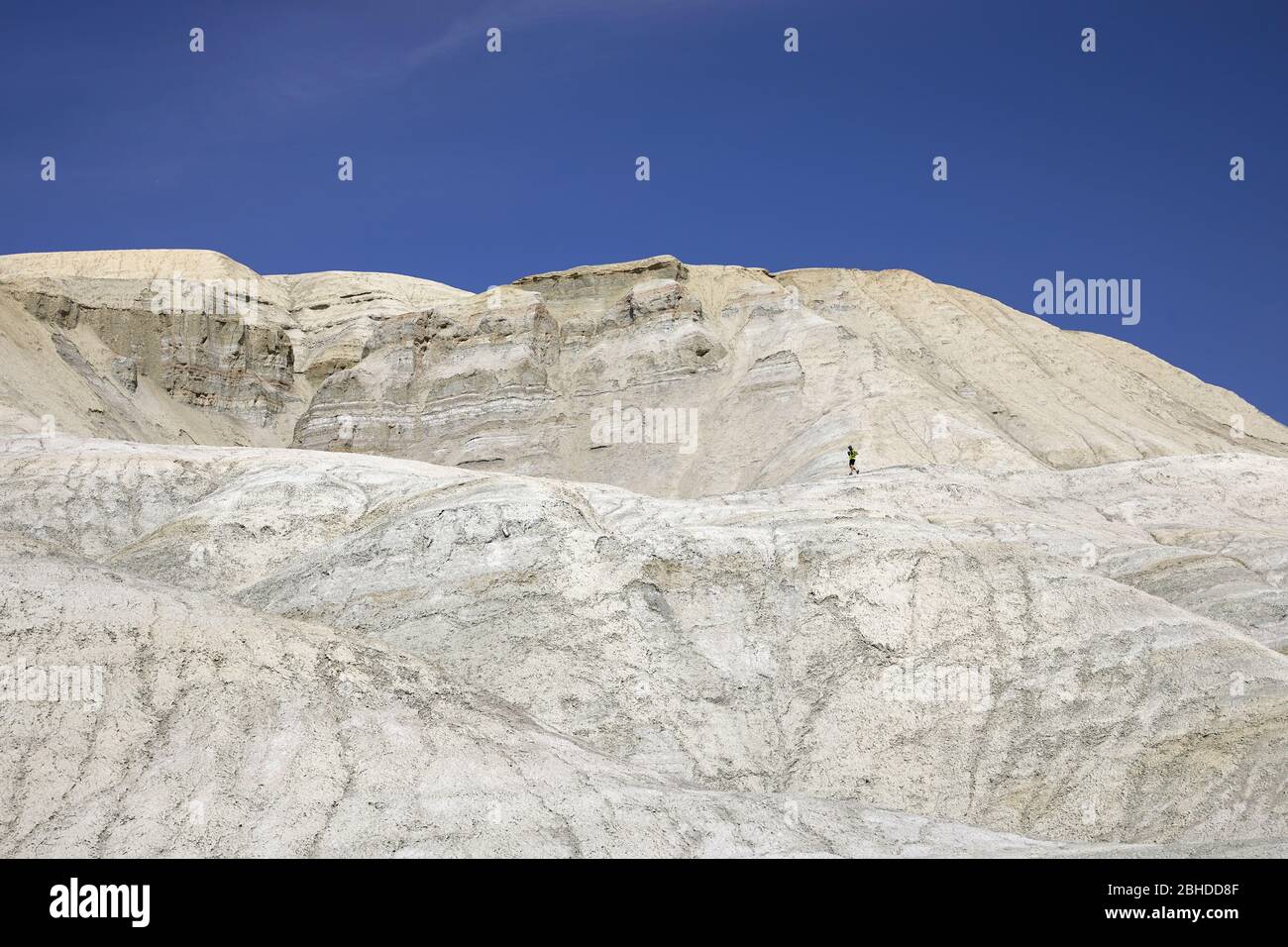 Runner athlete with beard running on the wild trail at white mountains ...