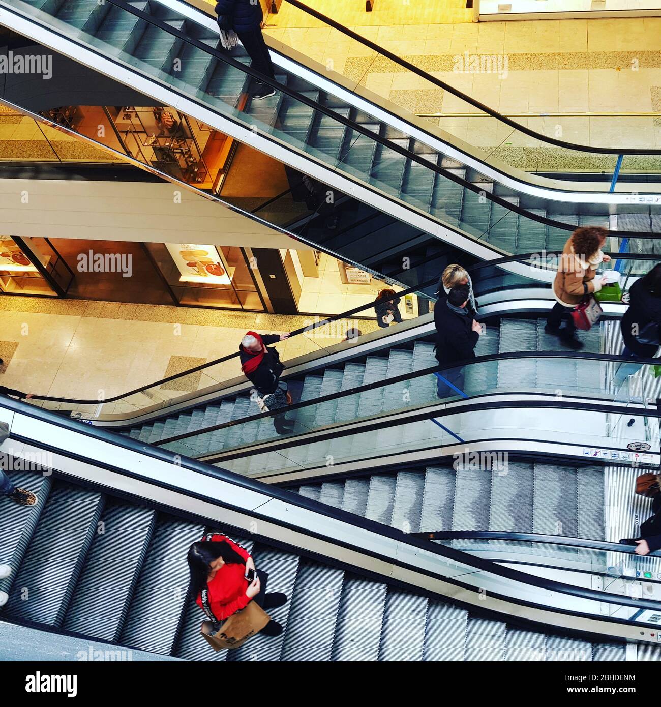 People on escalator in a modern buillding Stock Photo - Alamy