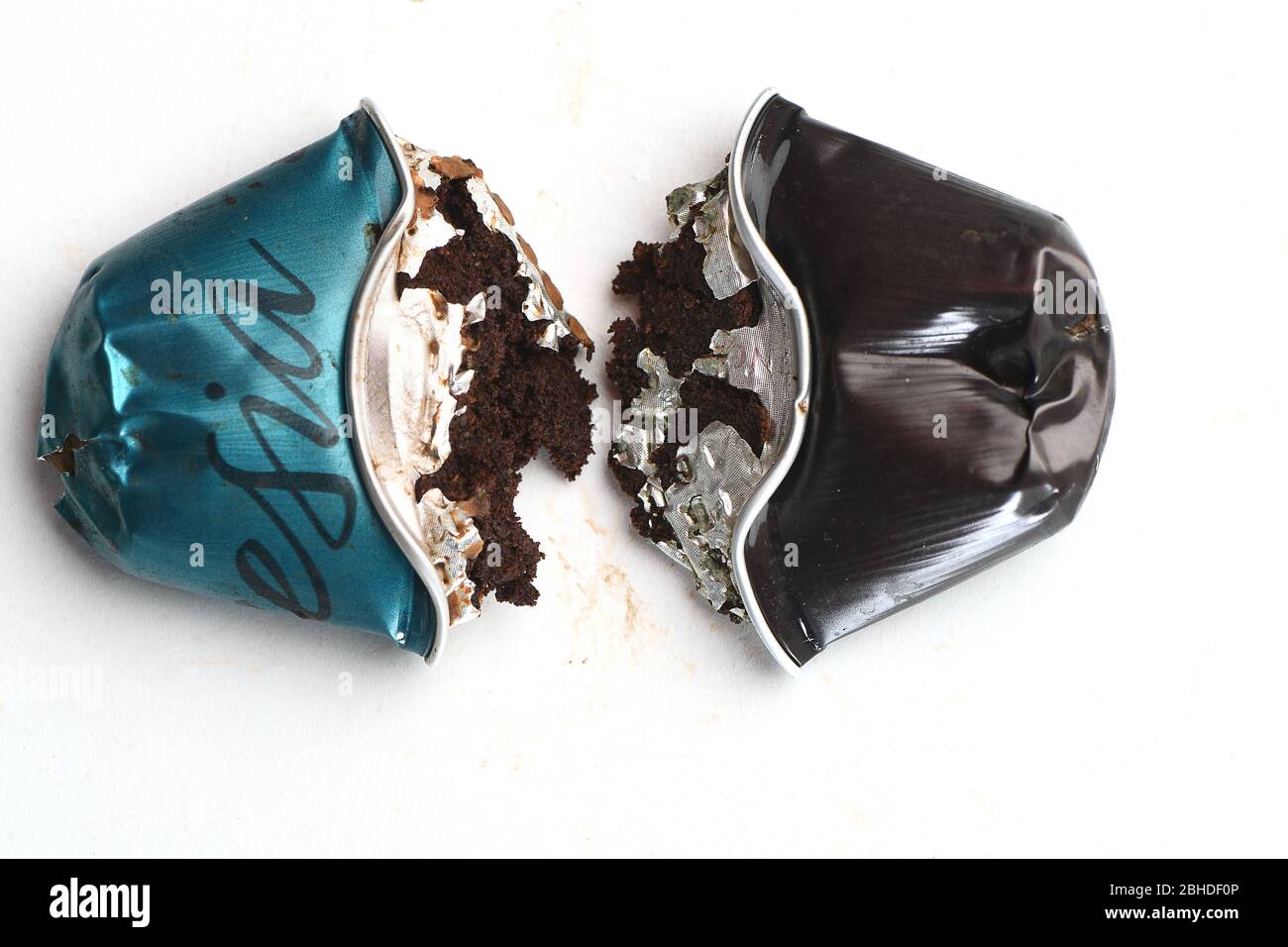 A close up of a Nespresso capsule crushed so coffee is forced out the ...