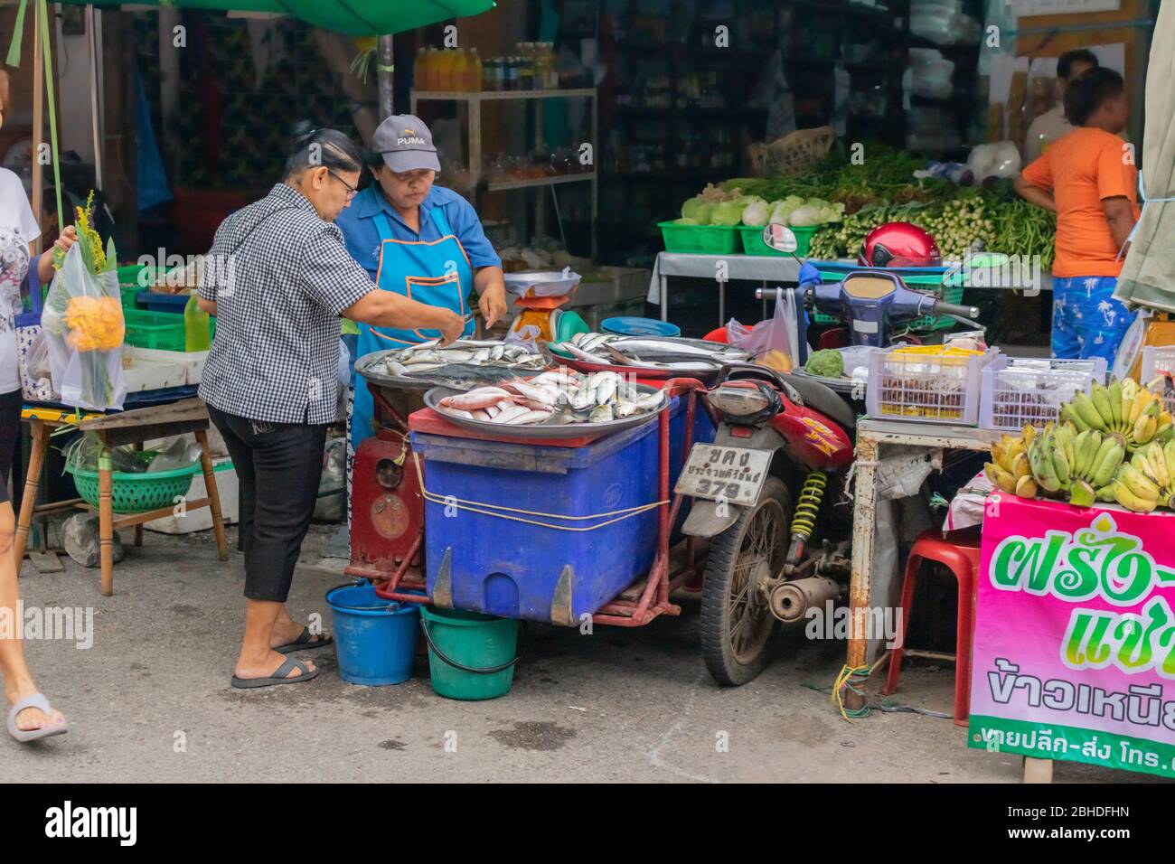 The fresh fish shop on the street with its vendor showing original Thai ...