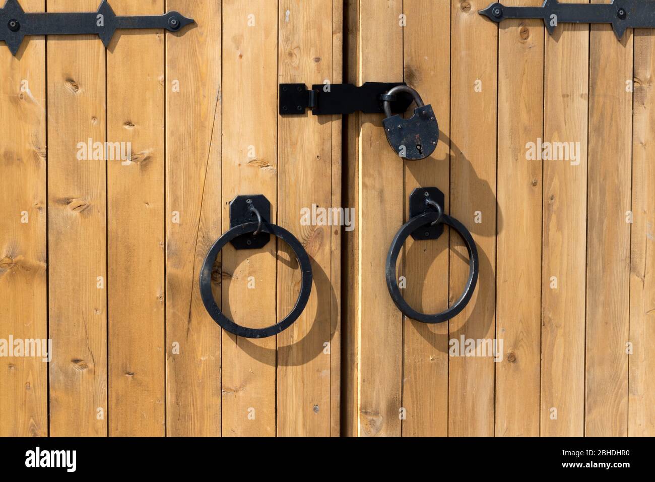 Wooden gate with metal handles close-up Stock Photo - Alamy