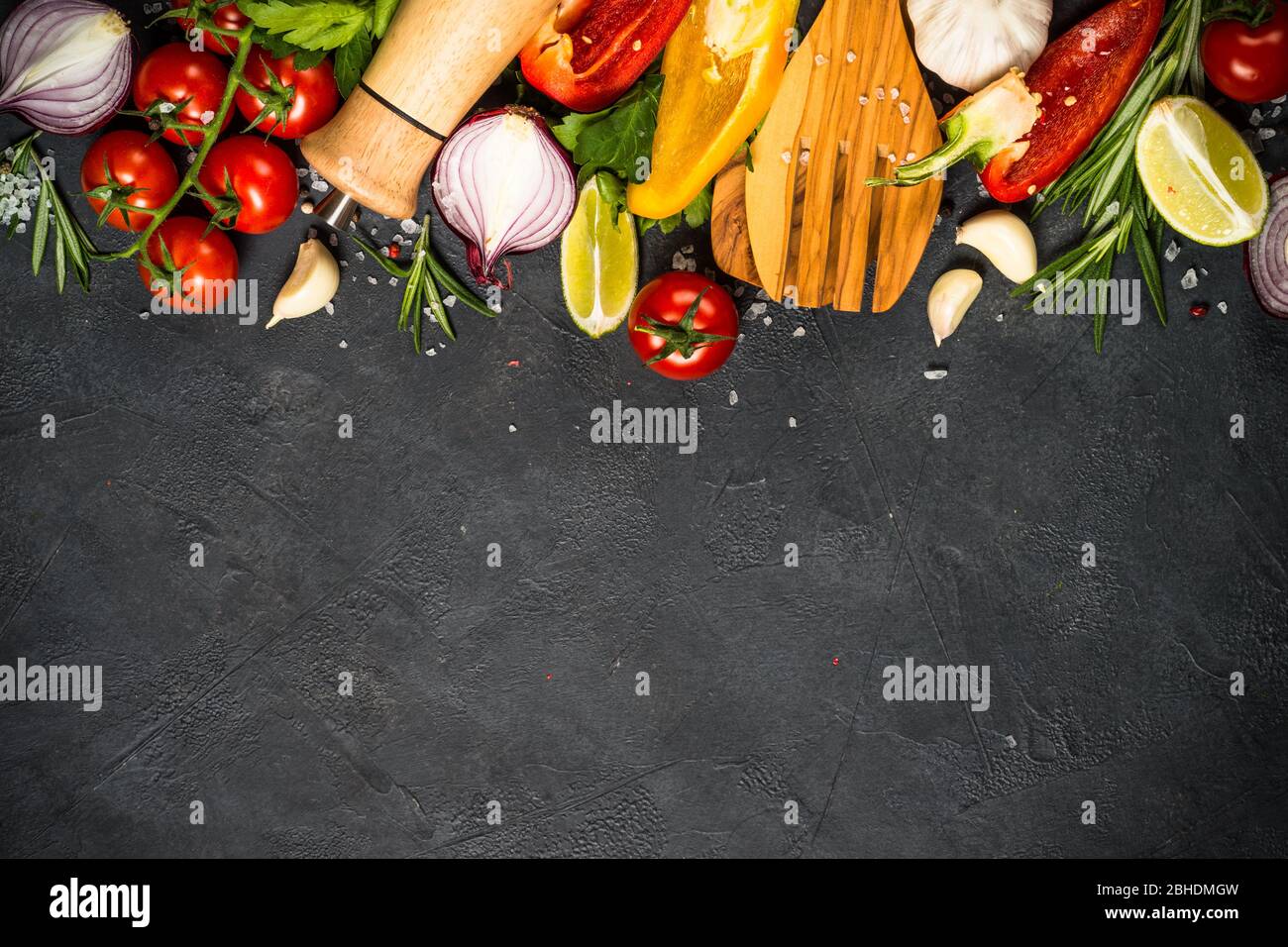 Food cooking background on black table Stock Photo - Alamy