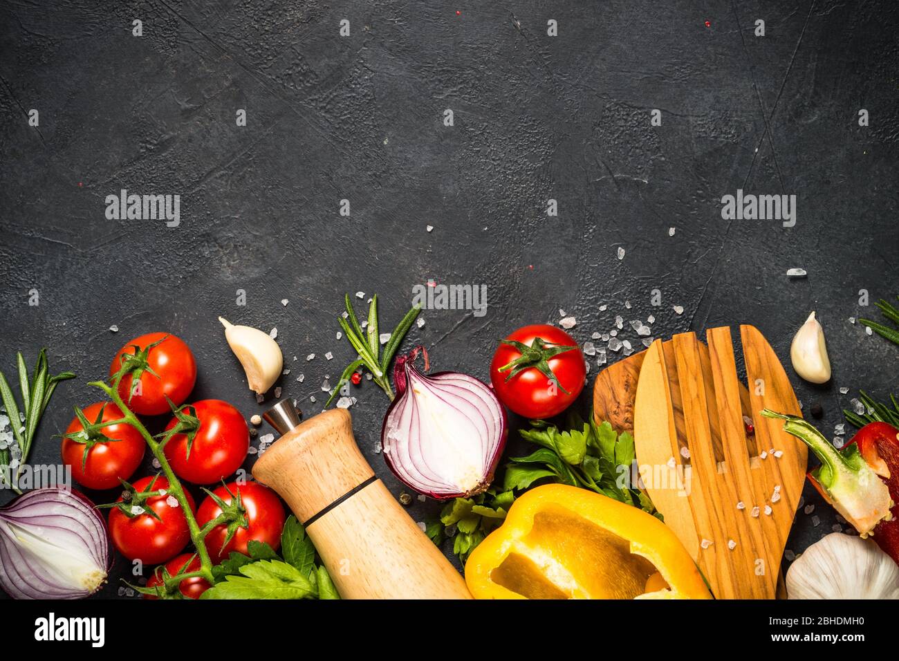 Food cooking background on black table Stock Photo - Alamy