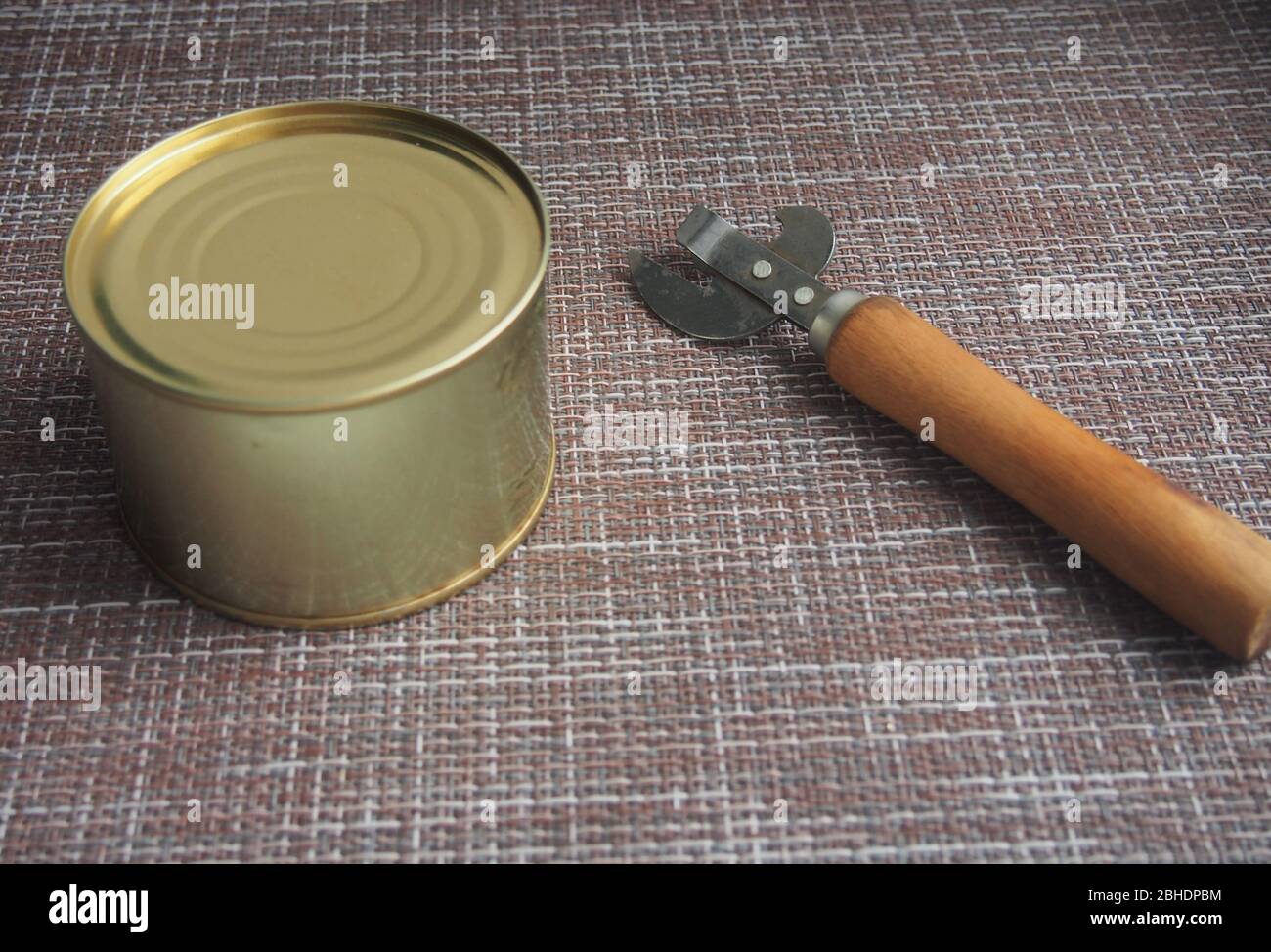 A tin can and a can opener. The opening of the cans. Still-life Stock ...