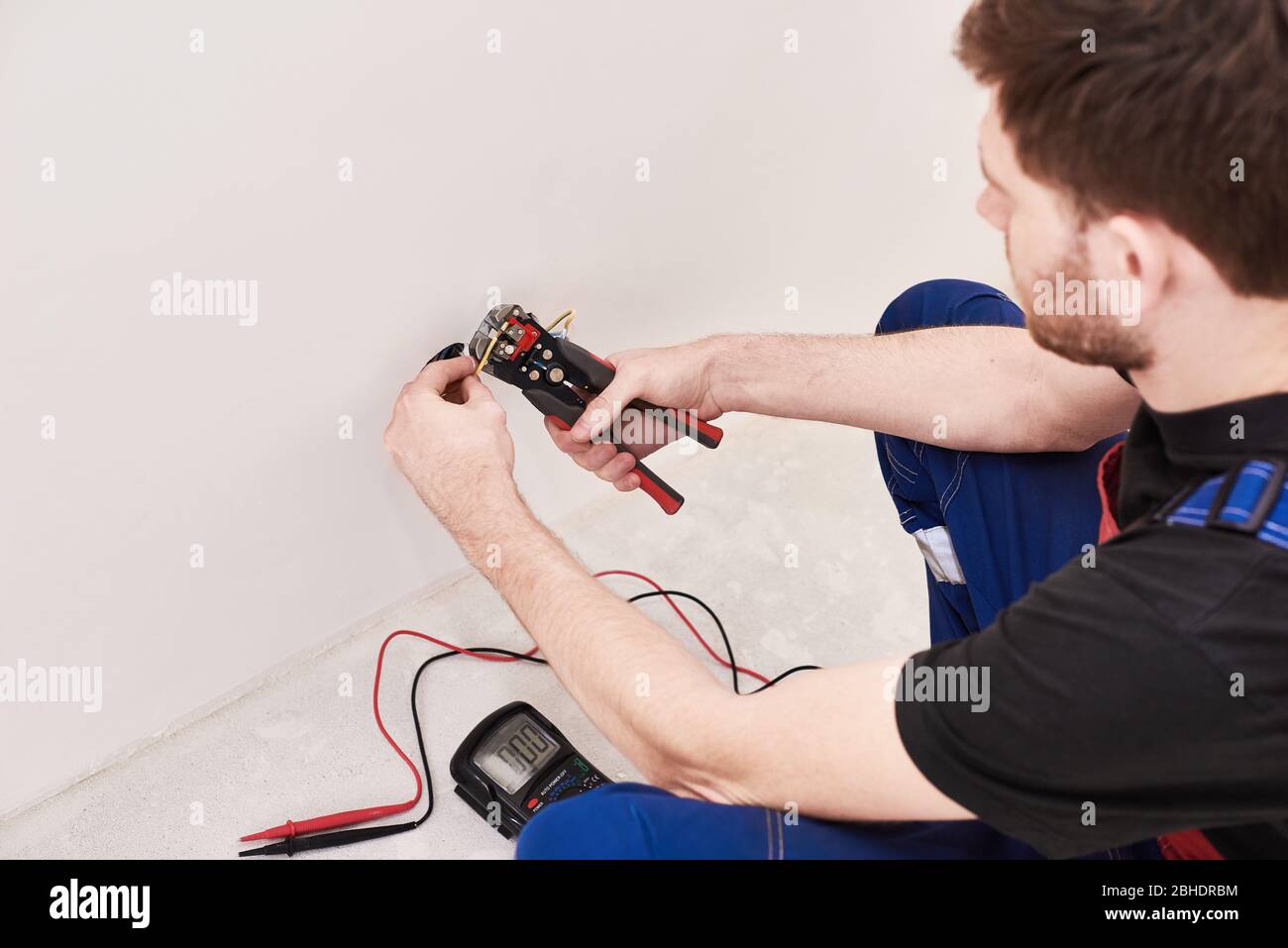 crimping pliers on the man hands. installation, repairs in the new flat ...
