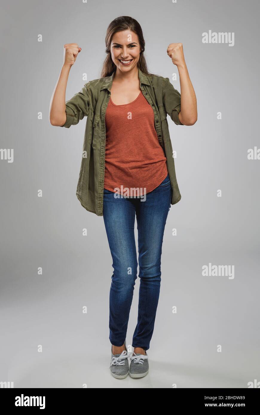 Beautiful and successful young woman with arms raised Stock Photo - Alamy