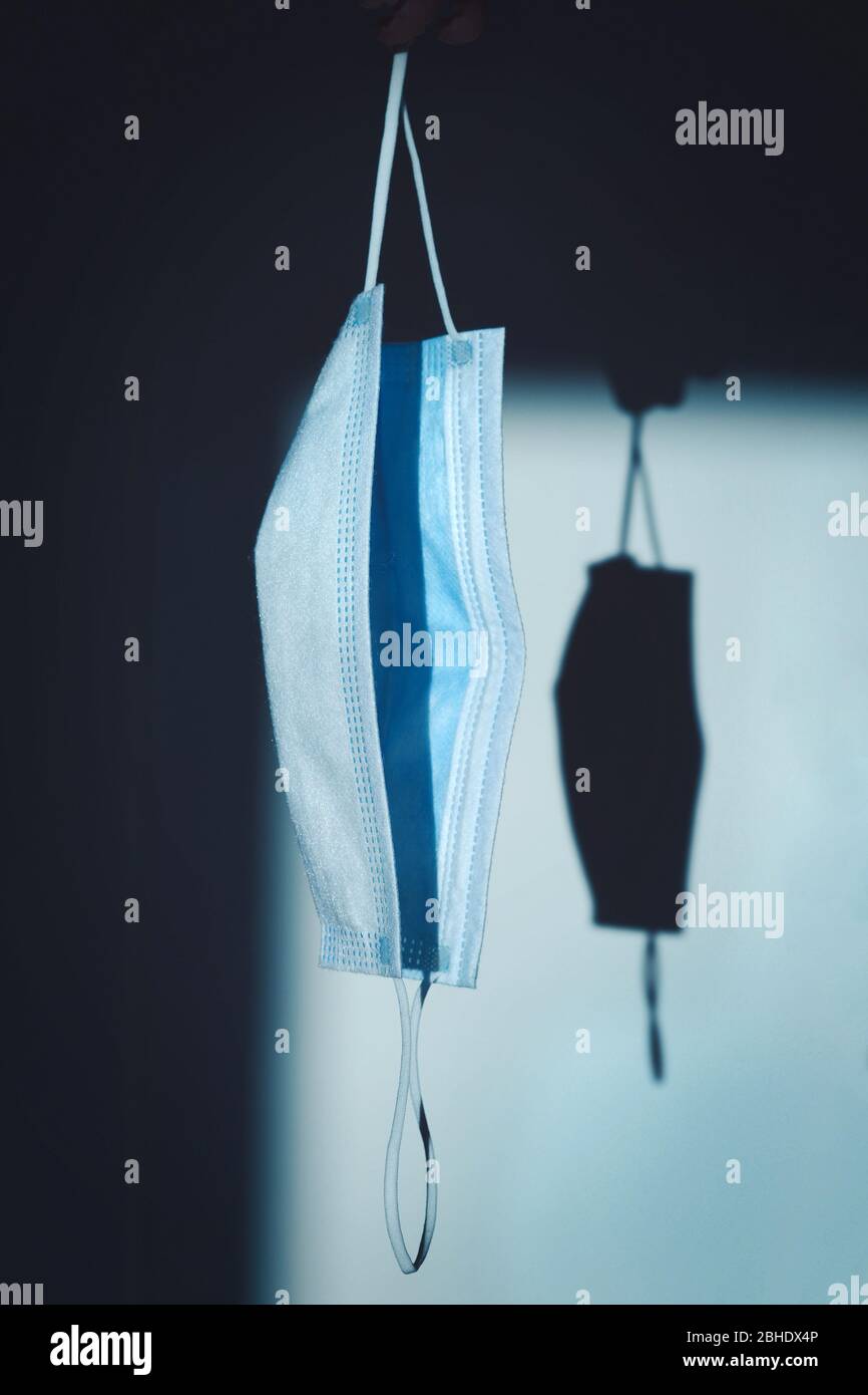 Hanging surgical face mask with shadow (concept failed or completed ...