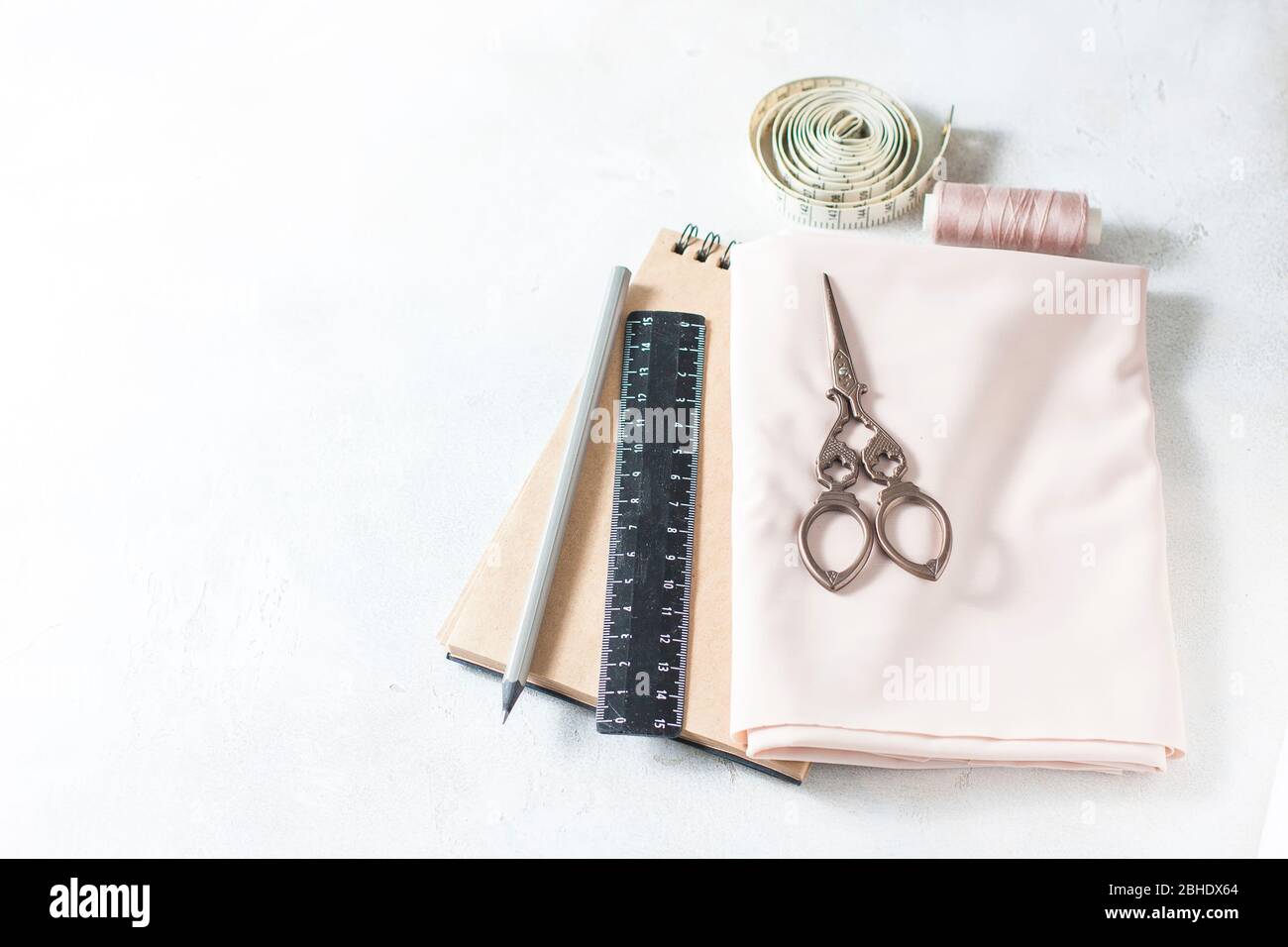 Everything for sewing. Beige fabric, sewing accessories and scissors ...