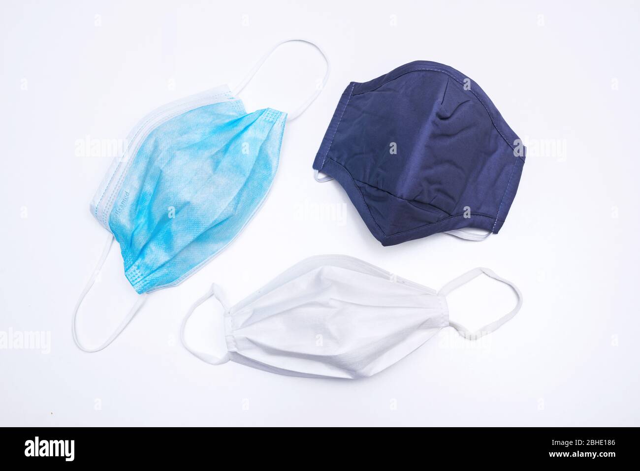 Big and small face mask tied to each other Stock Photo - Alamy