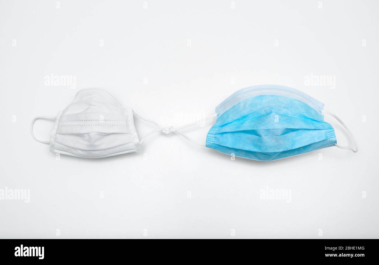 Big and small face mask tied to each other Stock Photo - Alamy